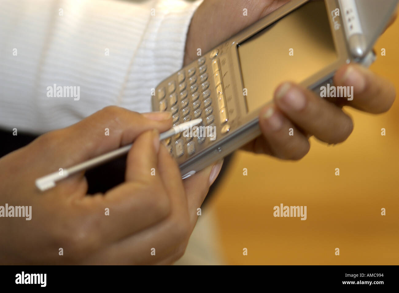 Latino Woman using a PDA organiser organizer Stock Photo - Alamy