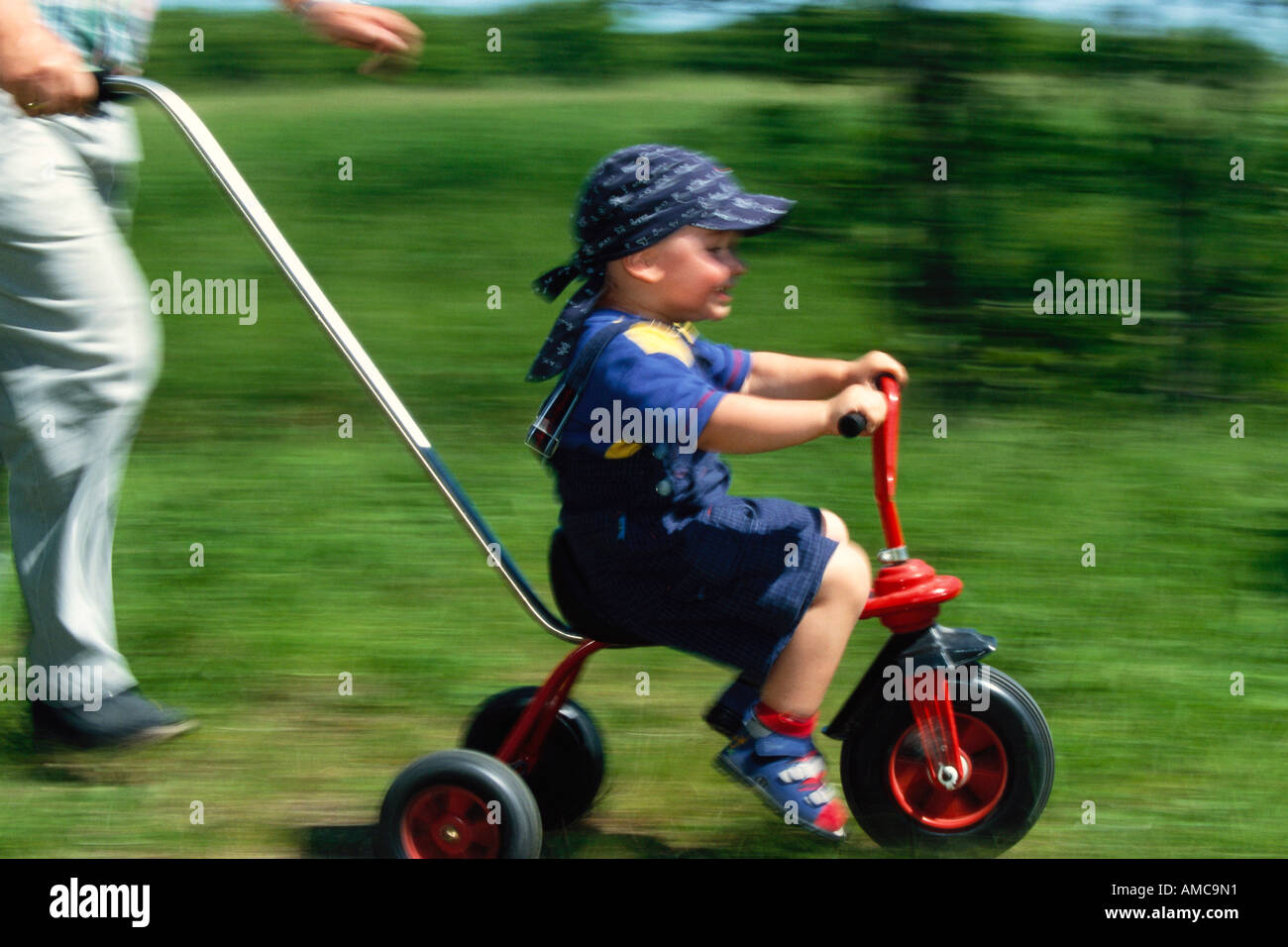 Child Being Pushed on Bicycle Stock Photo - Alamy