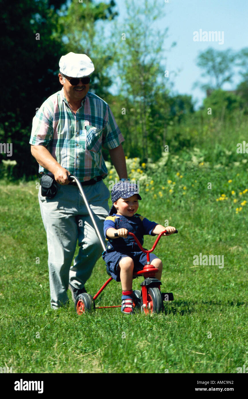 Child Being Pushed on Bicycle Stock Photo - Alamy