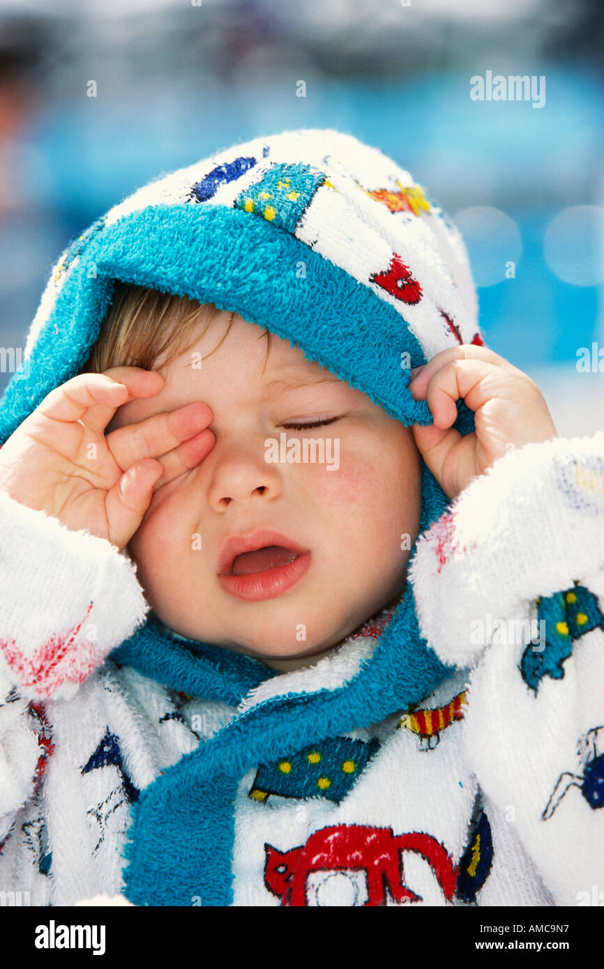 Boy rubbing head hi-res stock photography and images - Alamy