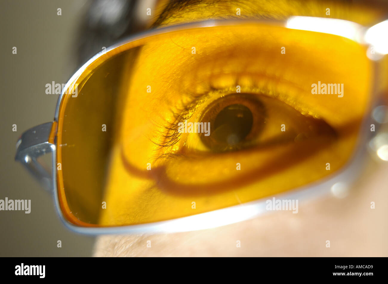 Eye eyes glasses yellow tinted lenses horizontal Stock Photo - Alamy