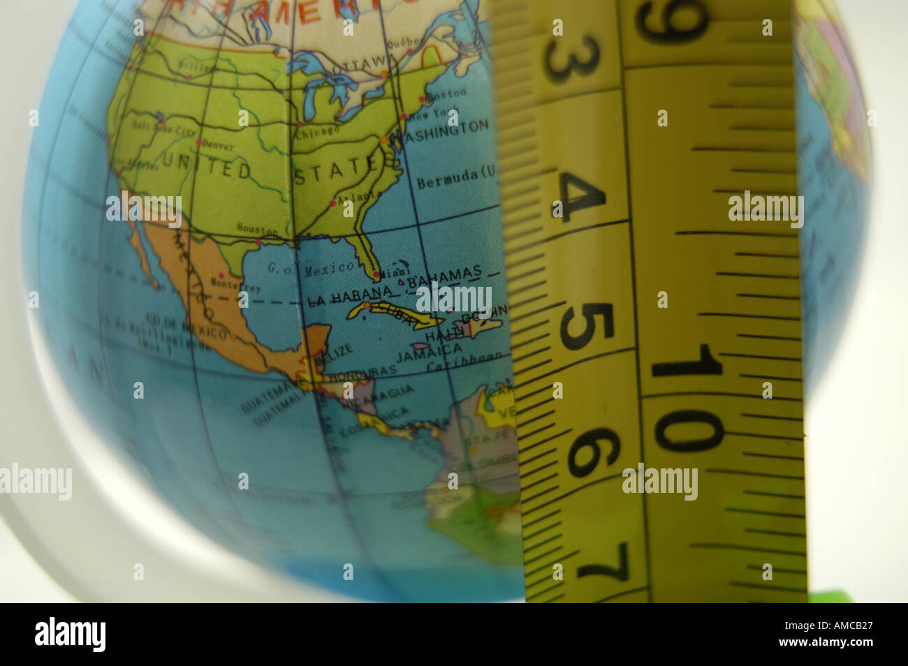 Measuring small globe with a yellow measure tape straight Stock Photo ...