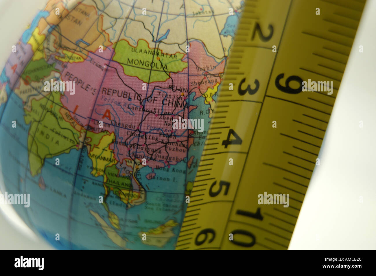 Measuring small globe with a yellow measure tape diagonal Stock Photo ...