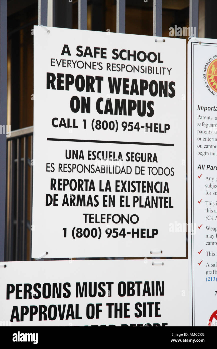 Sign on school fence warning against weapons Stock Photo - Alamy