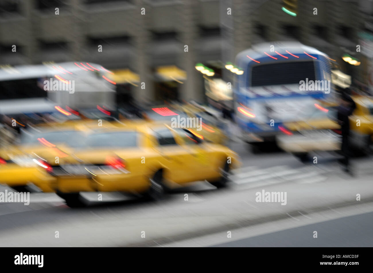 Yellow taxi from side behind back blue bus building bkgrnd background ...