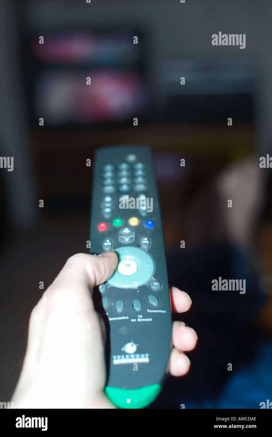 man using remote control pad for telewest cable television Stock Photo ...
