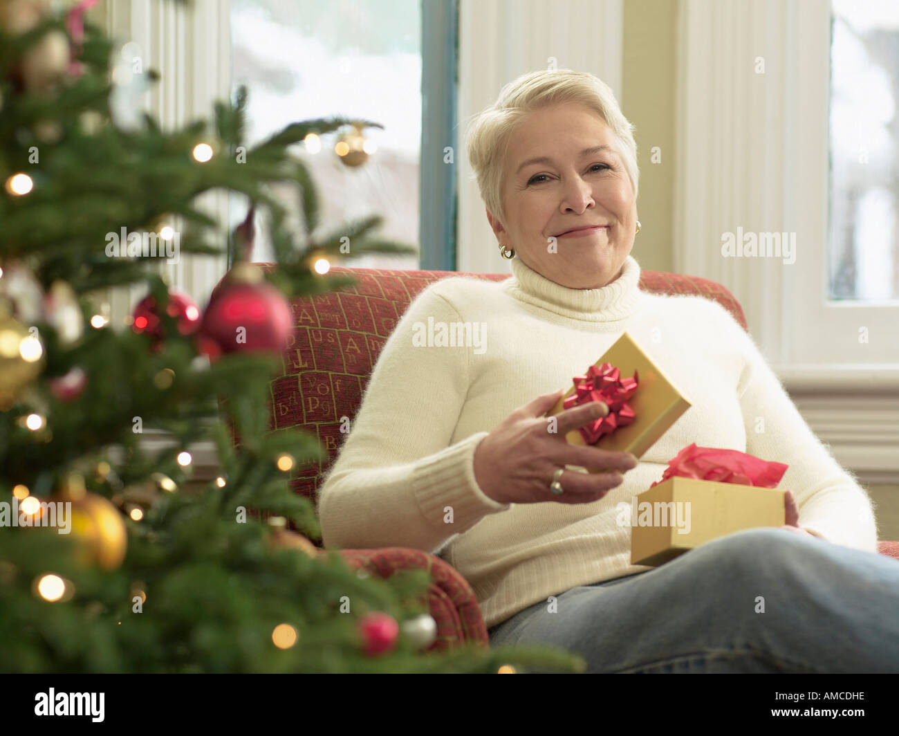Woman Opening Gift Stock Photo - Alamy