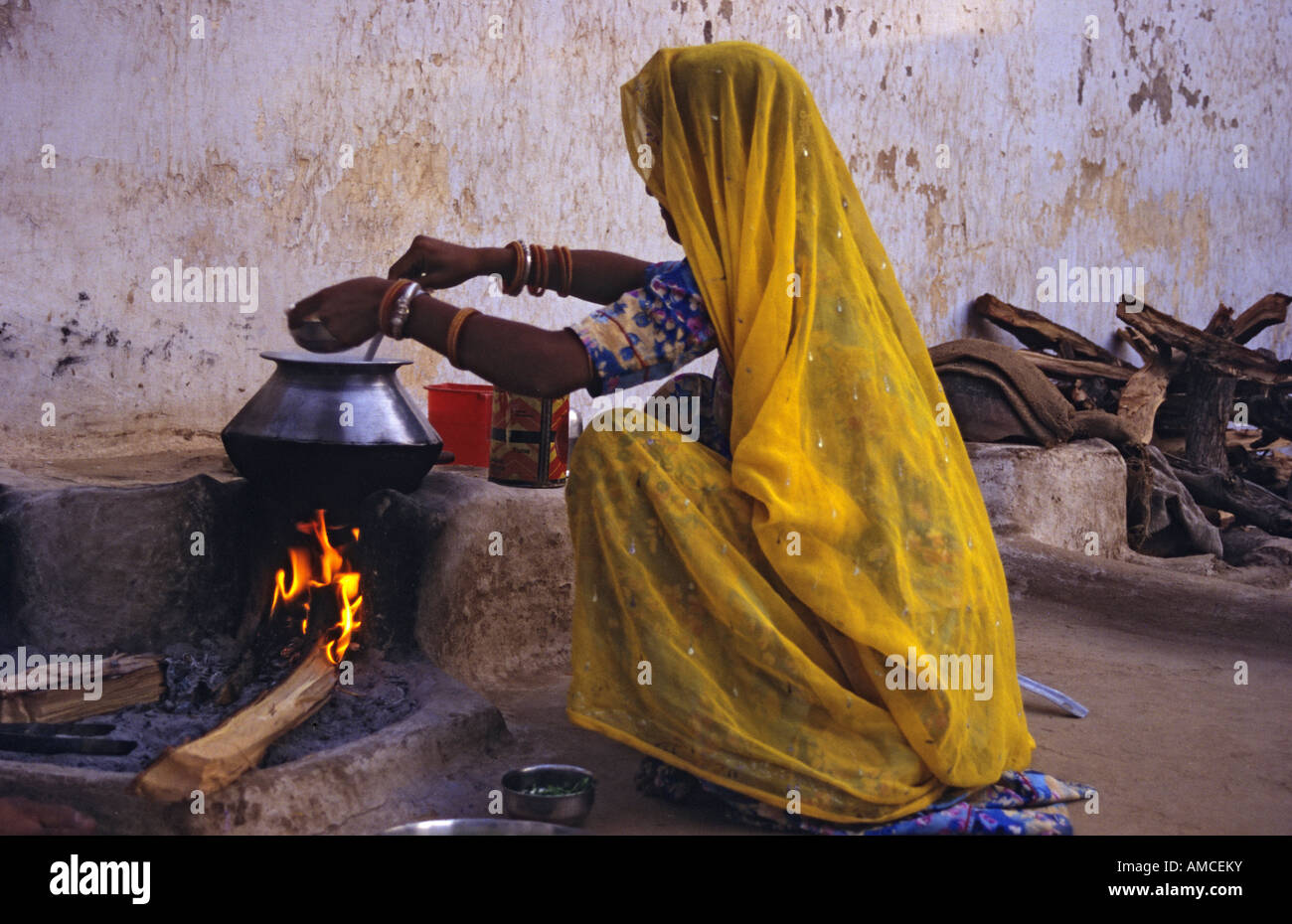 Indian woman cooking food on fire Stock Photo - Alamy