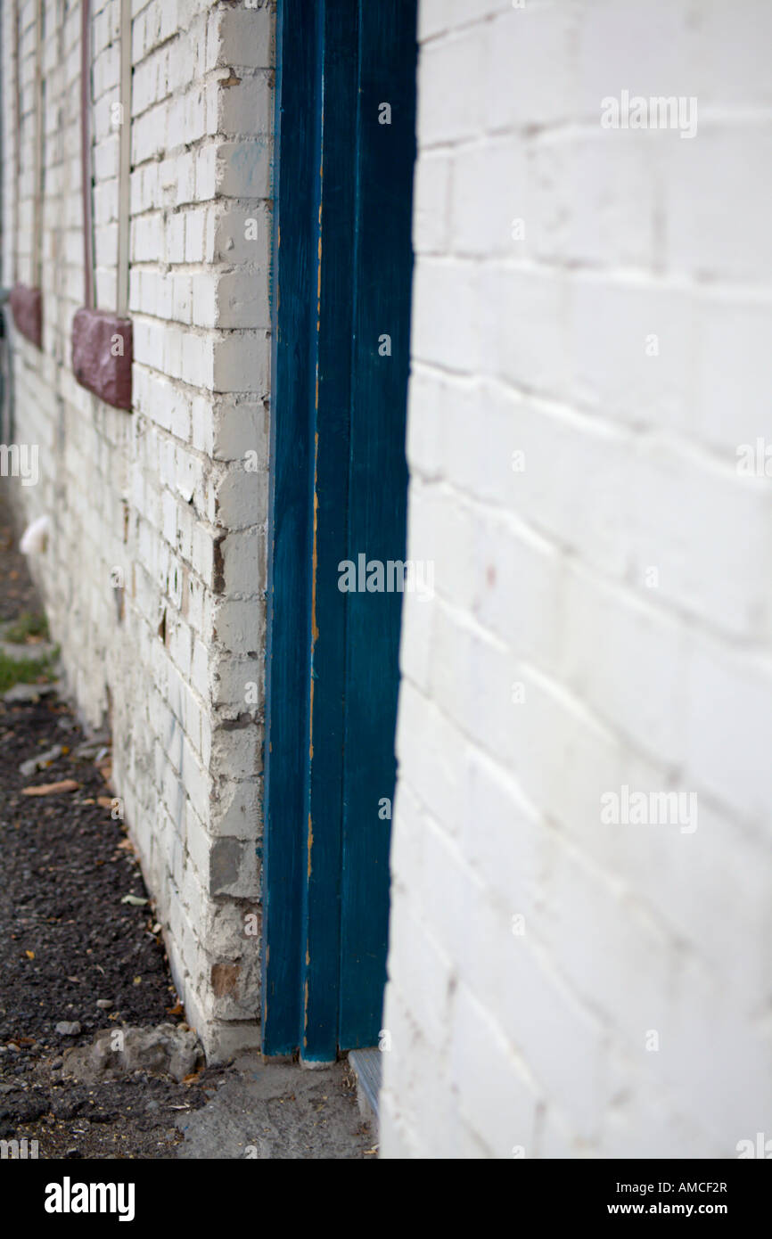 White brick wall with blue door jam Stock Photo - Alamy