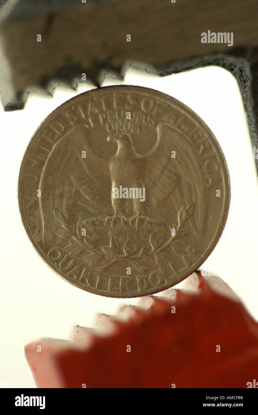U S quarter dollar coin in tool teeth vertical Stock Photo - Alamy