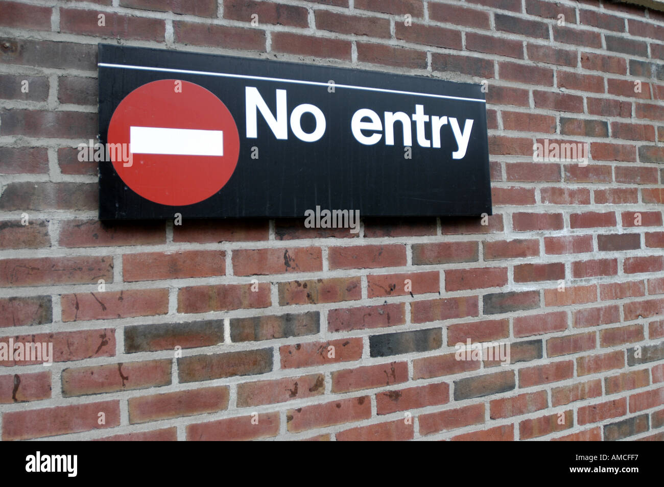Black sign white NO ENTRY red circle with white line brick wall Stock ...