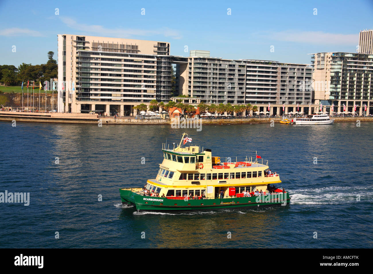 Sydney Harbour Ferry catamaran passing Office and Apartment Buildings ...