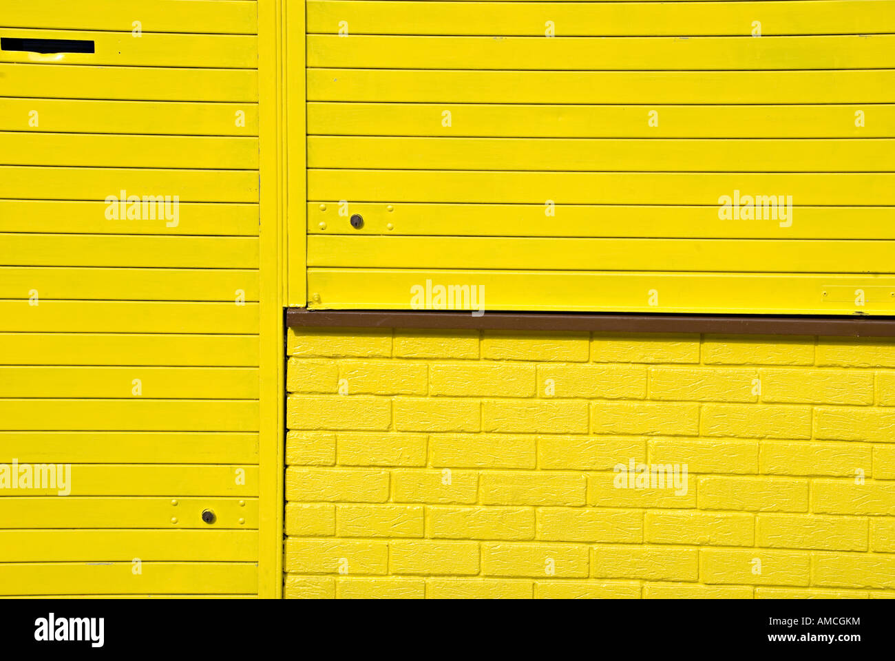 some abstract yellow shutters on a closed shop front in the uk Stock ...