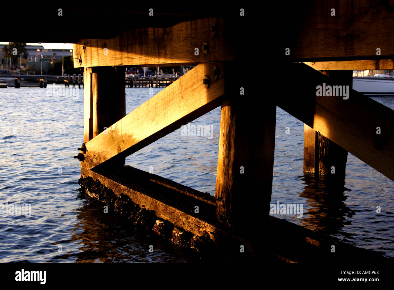 UNDERNEATH A TIMBER WHARF LATE AFTERNOON Stock Photo - Alamy