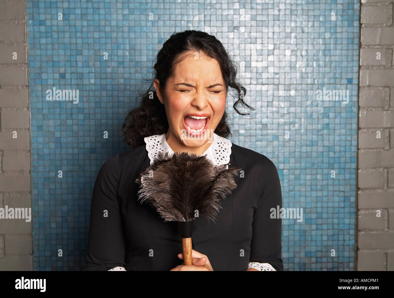 Maid Holding Duster and Screaming Stock Photo - Alamy