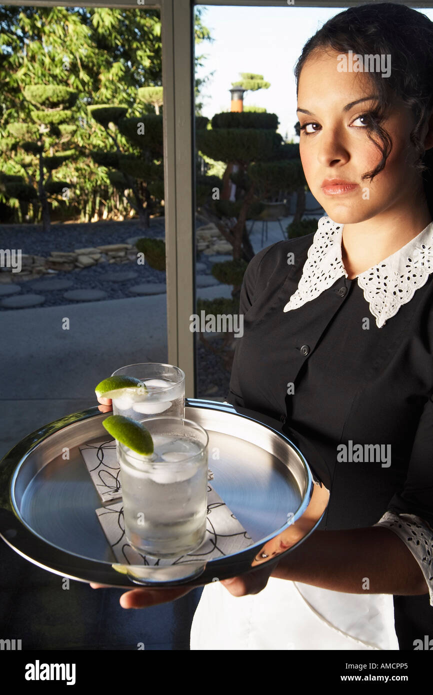 A Maid Holding Tray With Drinks Stock Photo - Alamy