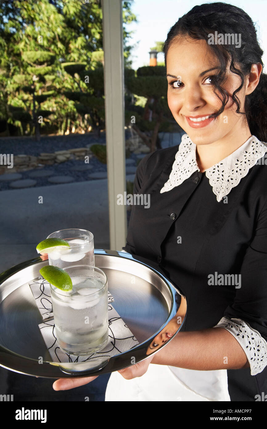 A Maid Holding Tray With Drinks Stock Photo - Alamy