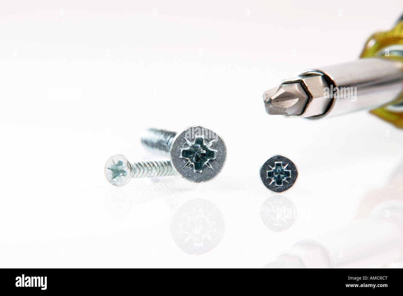 screwdiver detail and screws on white background industrial and ...