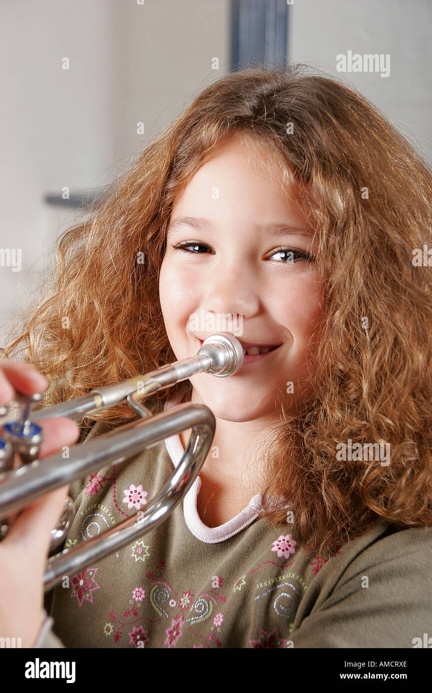 Teen girl playing trumpet hi-res stock photography and images - Alamy