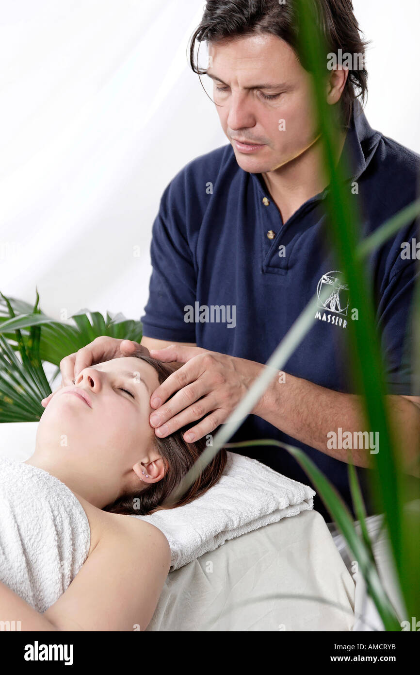 Young woman receiving head massage eyes closed Stock Photo - Alamy
