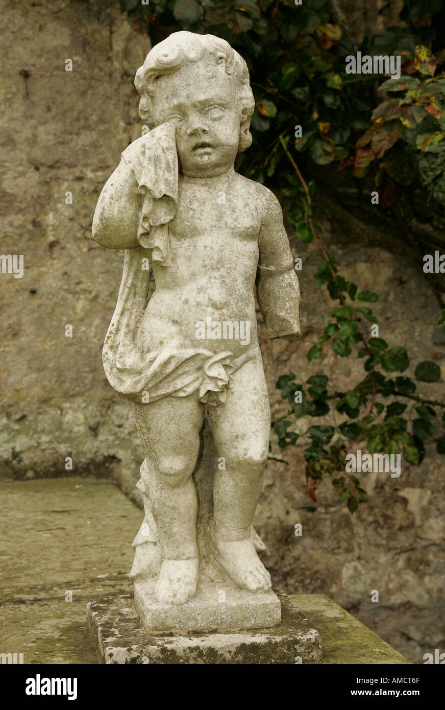 Old stone statue of a crying child Stock Photo - Alamy