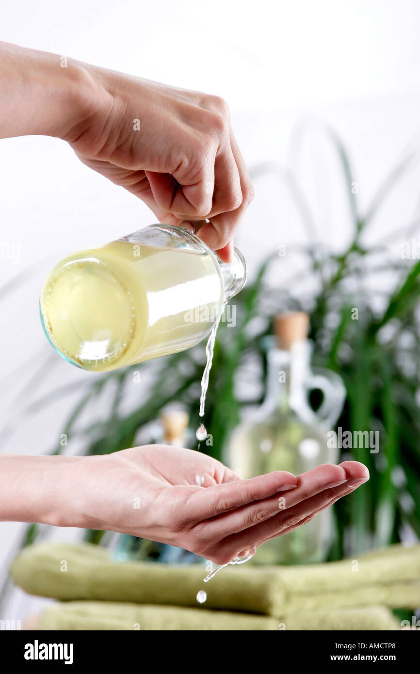 Woman pouring oil on hands hi-res stock photography and images - Alamy