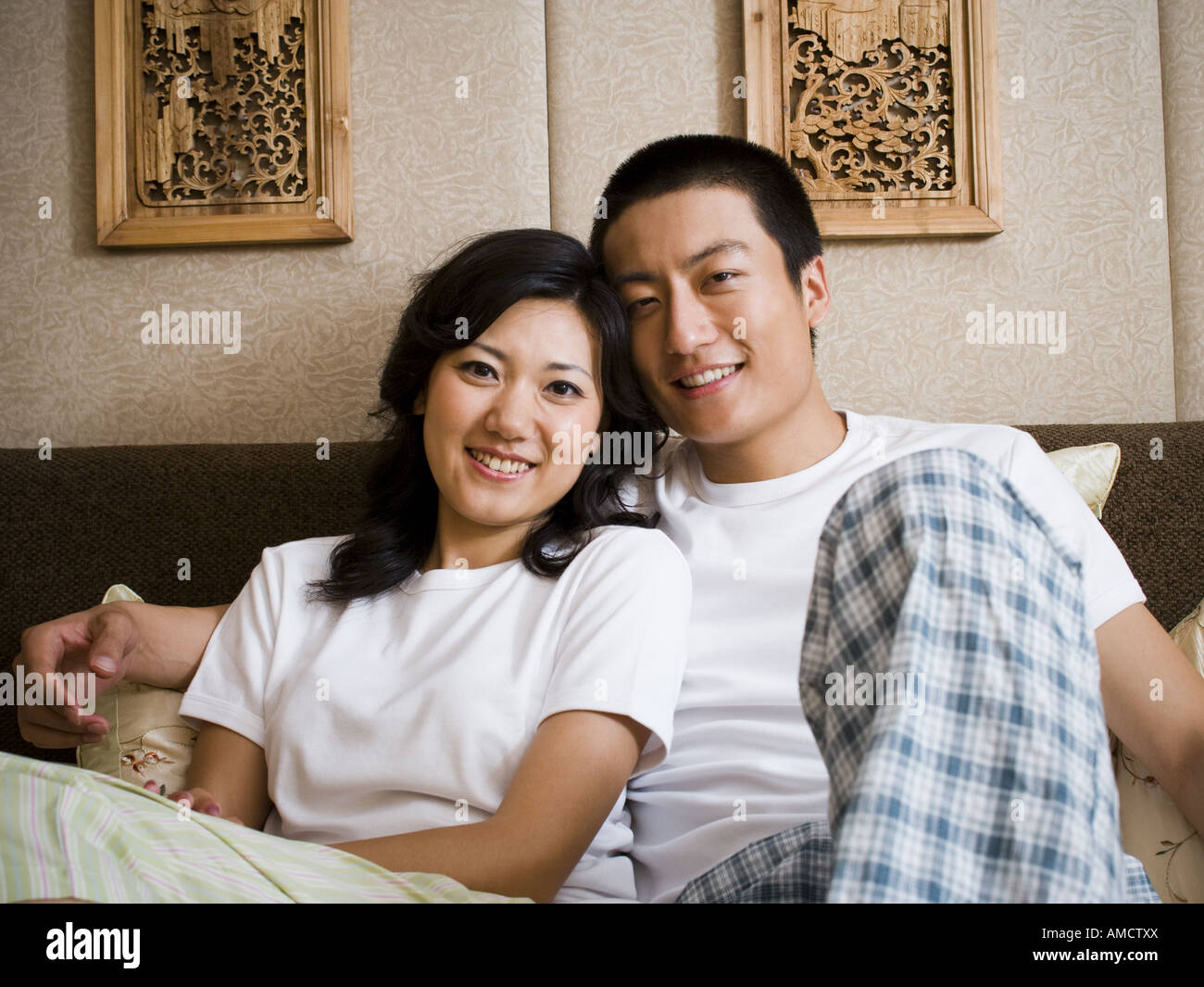Couple in bed hugging and smiling Stock Photo - Alamy