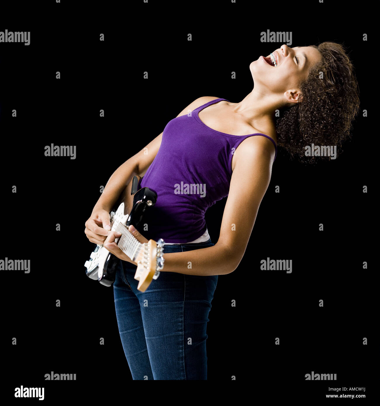 Girl playing electric guitar and singing Stock Photo - Alamy