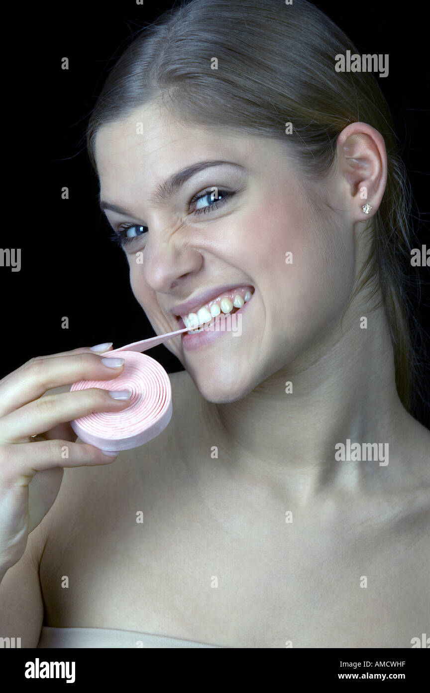 Girl chewing rubber Stock Photo - Alamy