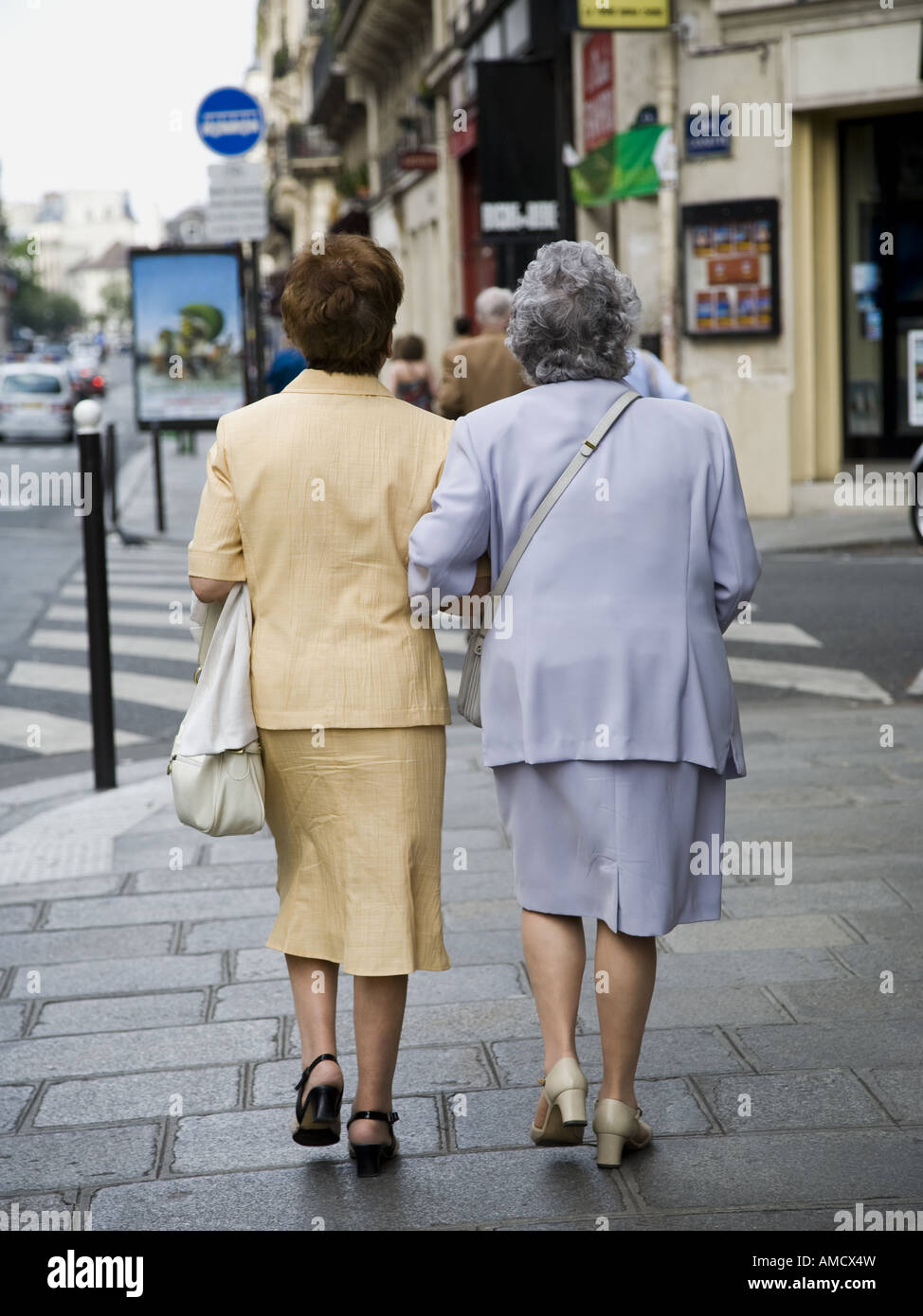 Rear view of two women walking on sidewalk outdoors Stock Photo - Alamy