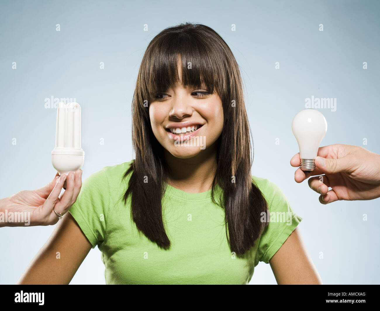 Woman with fluorescent and incandescent light bulbs Stock Photo - Alamy