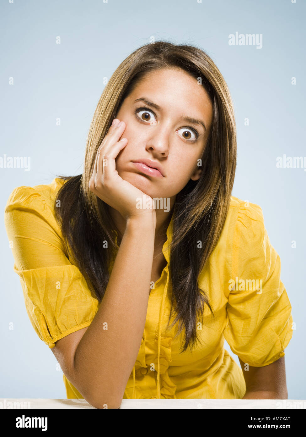 Bored woman sitting and staring Stock Photo - Alamy