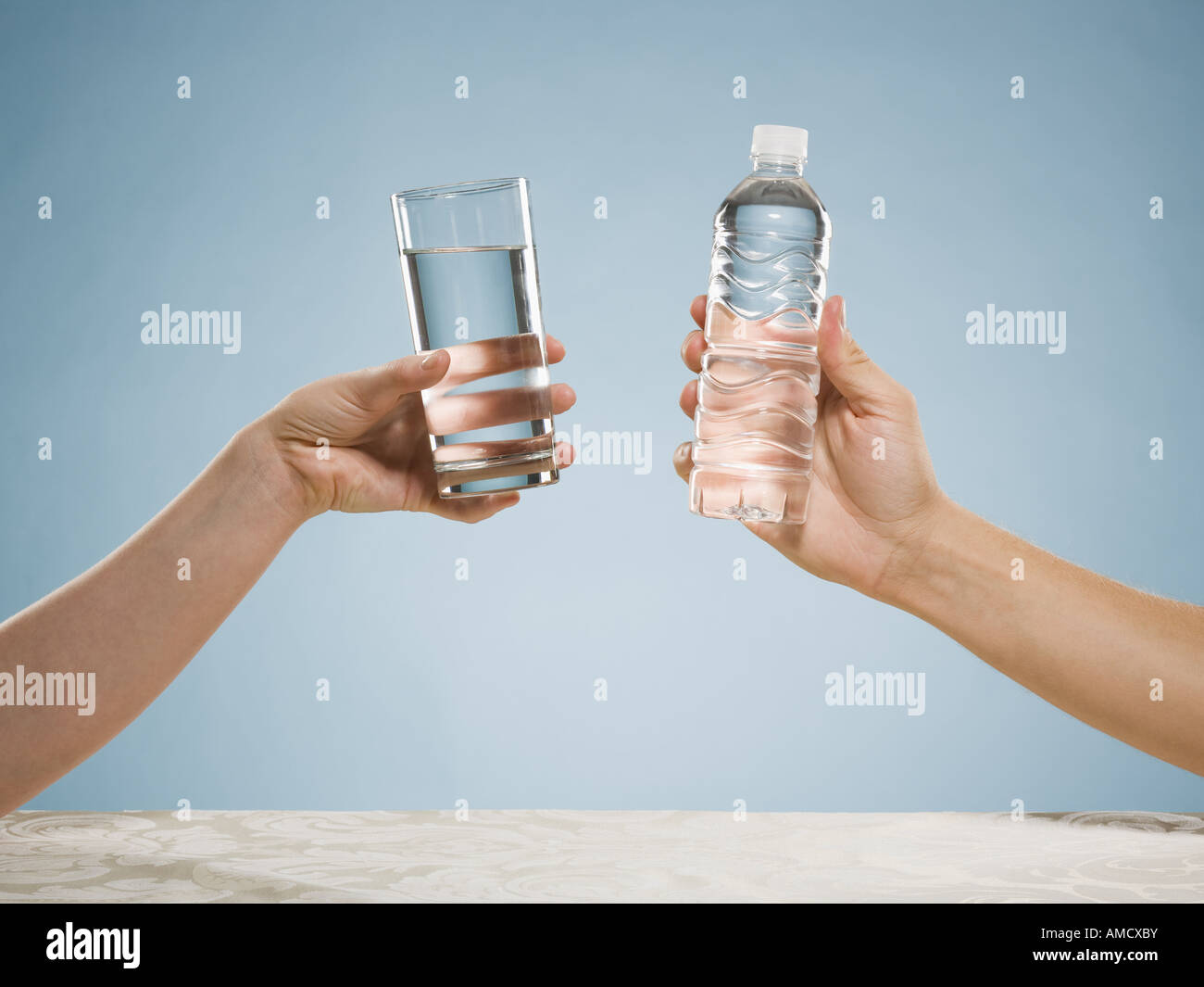 Hand holding glass of water and hand holding bottled water Stock Photo ...