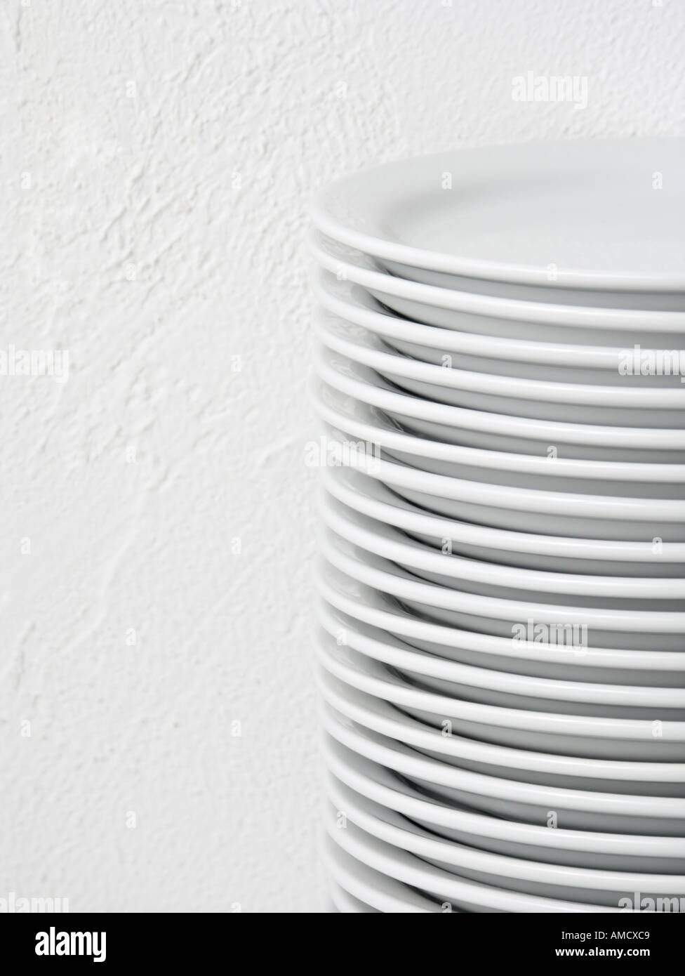 Stack of round white dinner plates on a white background Stock Photo ...