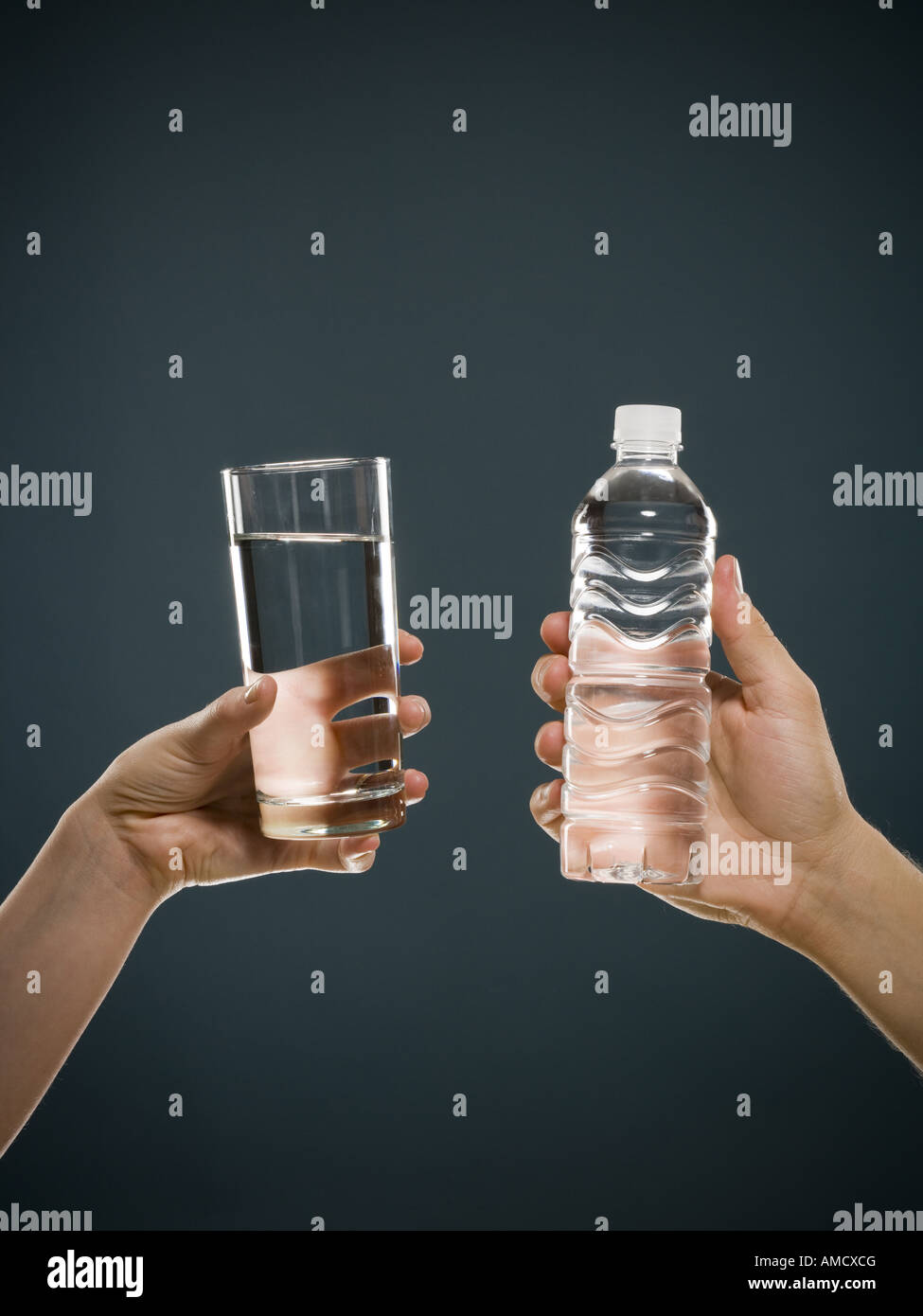 Hand holding glass of water and hand holding bottled water Stock Photo ...