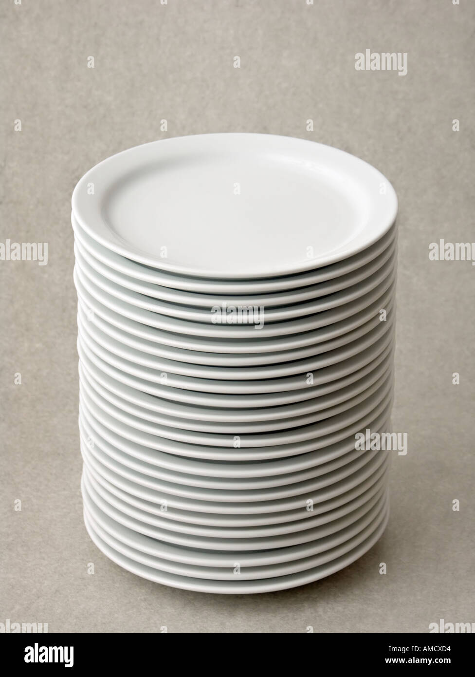 Stack of round white dinner plates Stock Photo - Alamy