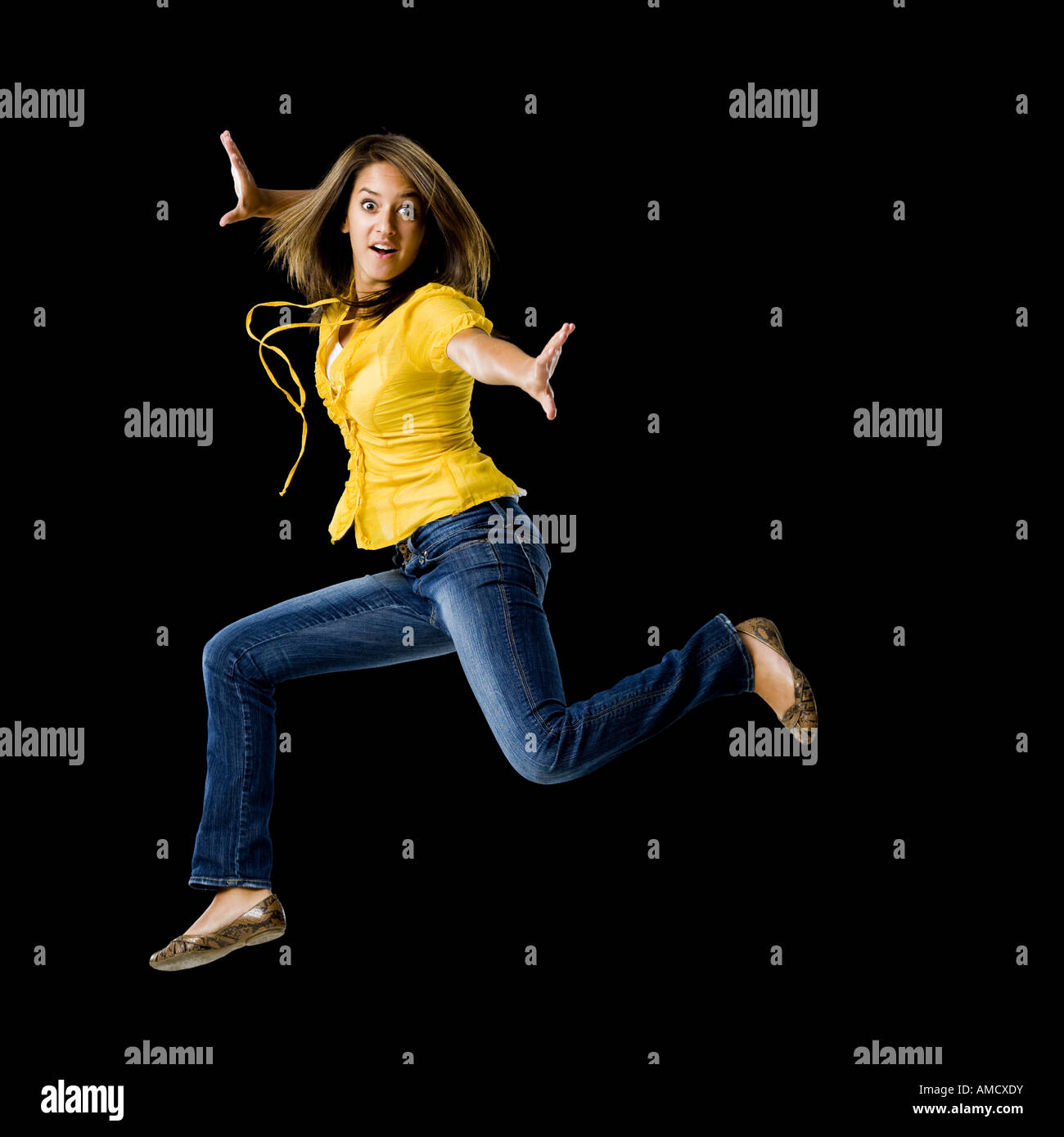 Full length woman dancing with arms up Stock Photo - Alamy