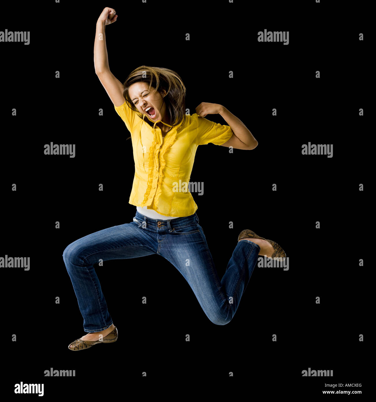 Woman leaping with arms raised Stock Photo - Alamy