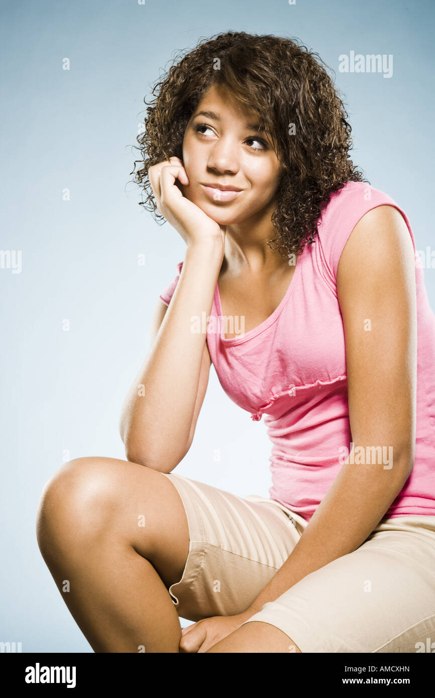 Girl sitting and thinking Stock Photo - Alamy