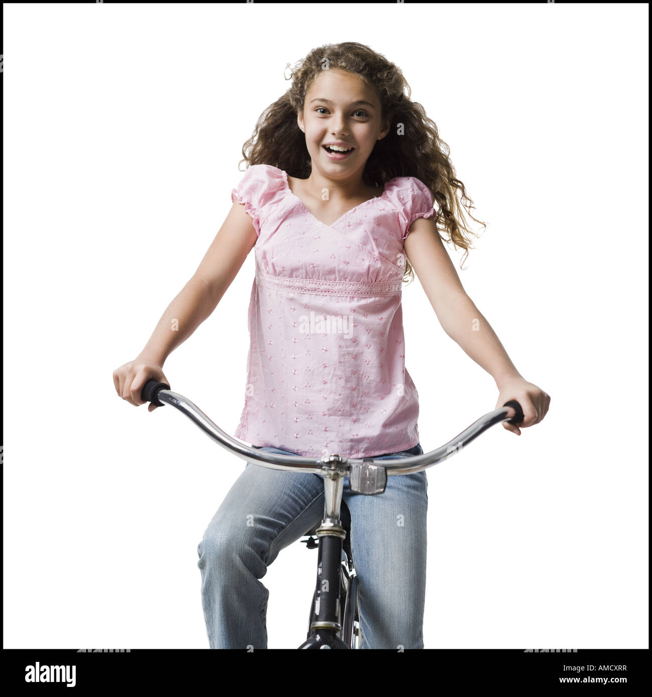 Girl riding bicycle smiling Stock Photo - Alamy
