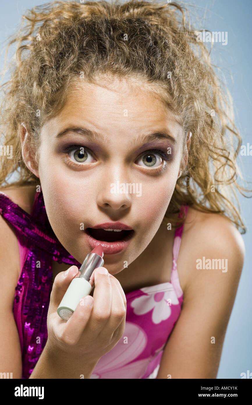 Closeup of girl applying lipstick Stock Photo - Alamy