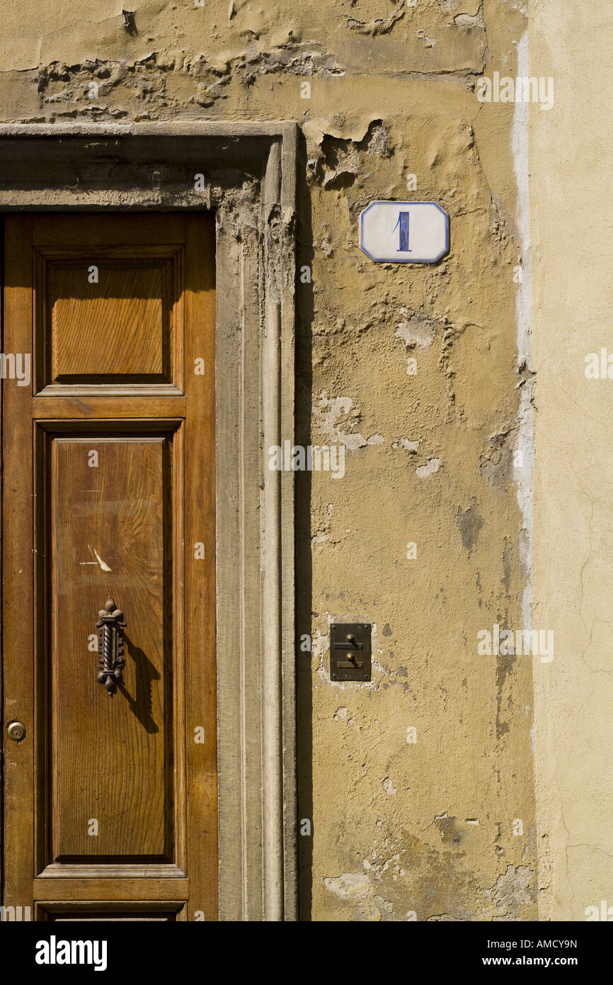 Detail of number one on wall with wooden door Stock Photo - Alamy
