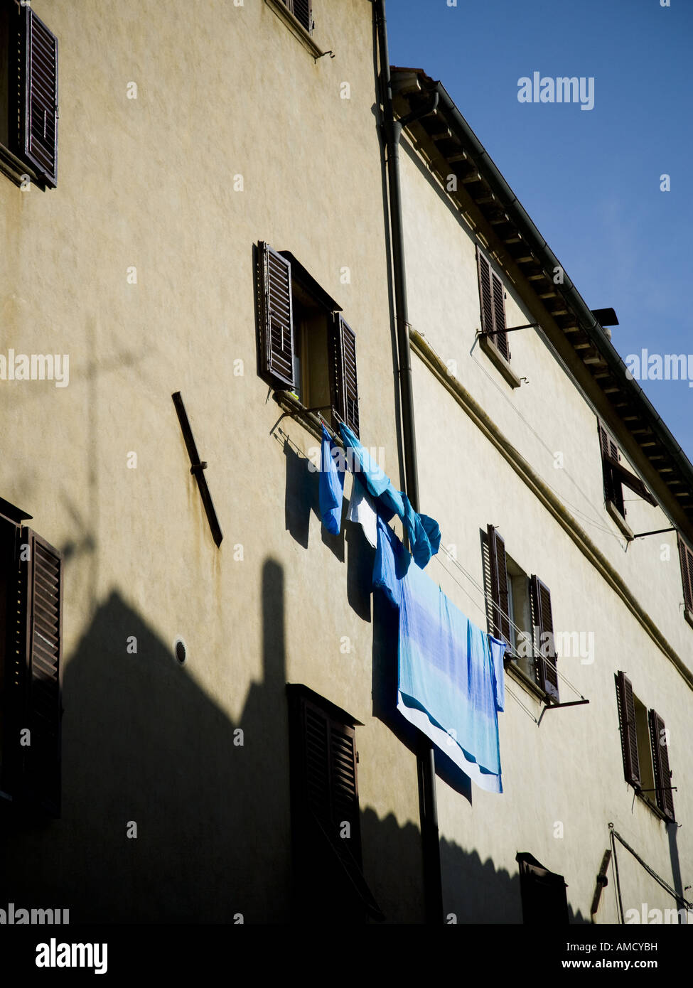 Clothes hanging from clothesline out window in building Stock Photo - Alamy