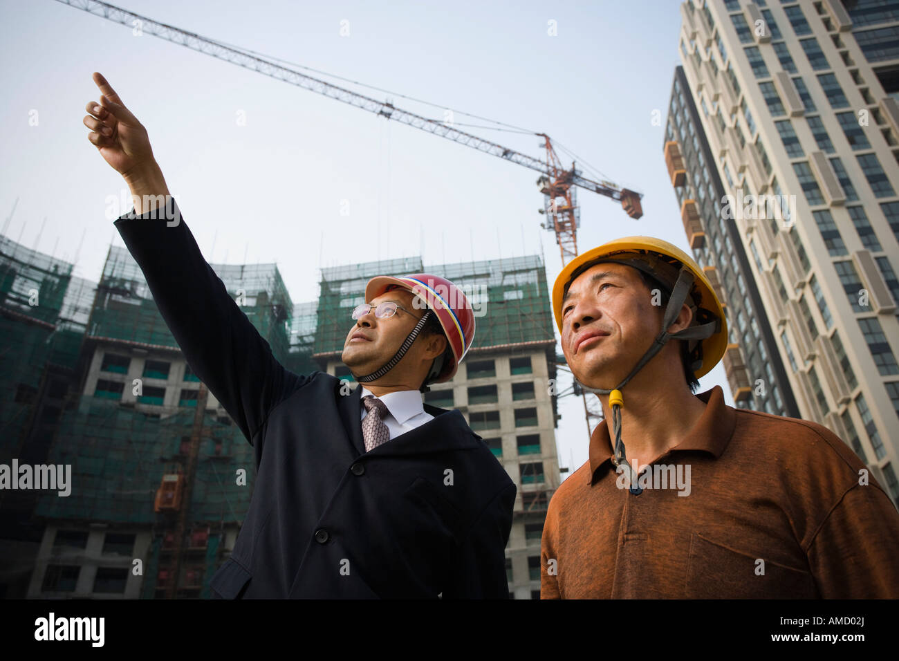 Men on a construction site in China Stock Photo - Alamy