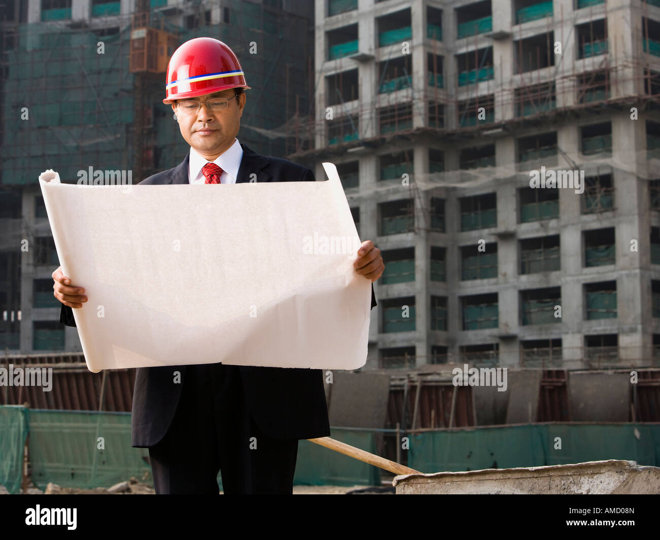 Construction site foreman with blueprints outdoors Stock Photo - Alamy