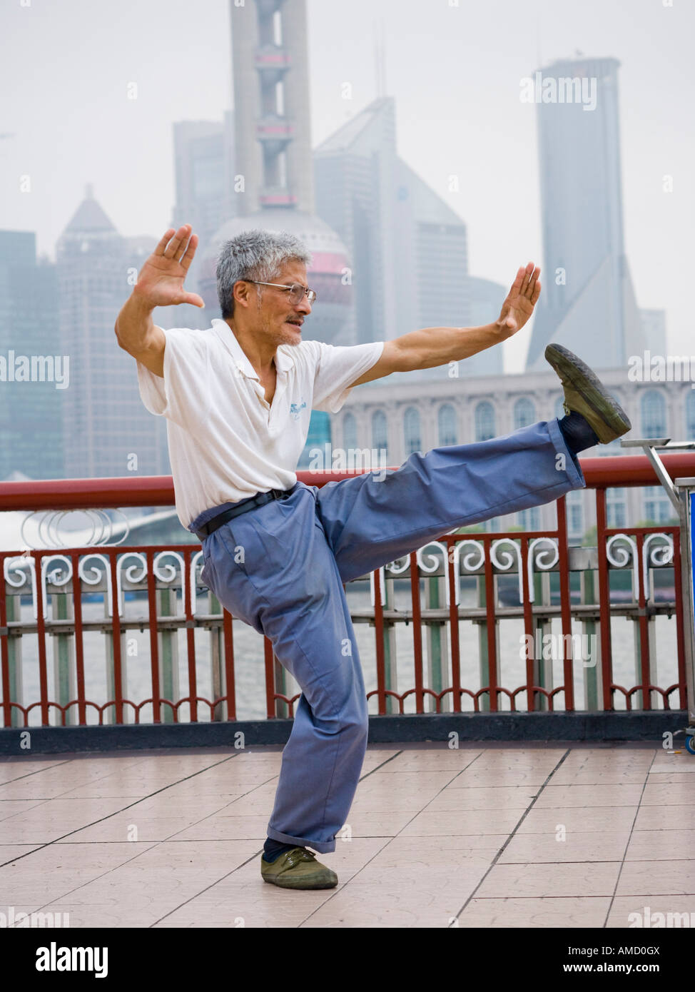 Man doing tai chi outdoors with city skyline in background Stock Photo ...