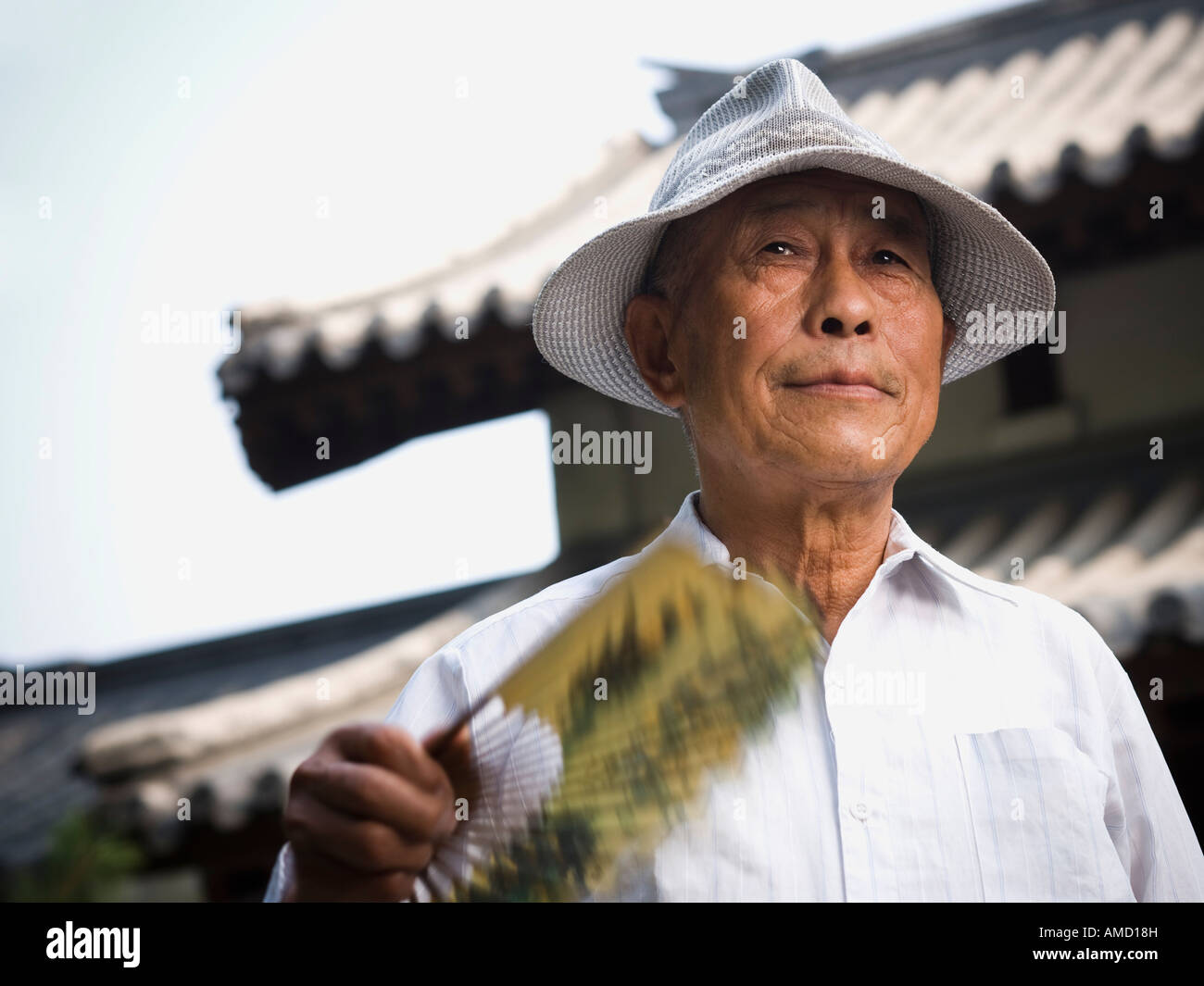 Man outdoors holding sunhat hi-res stock photography and images - Alamy