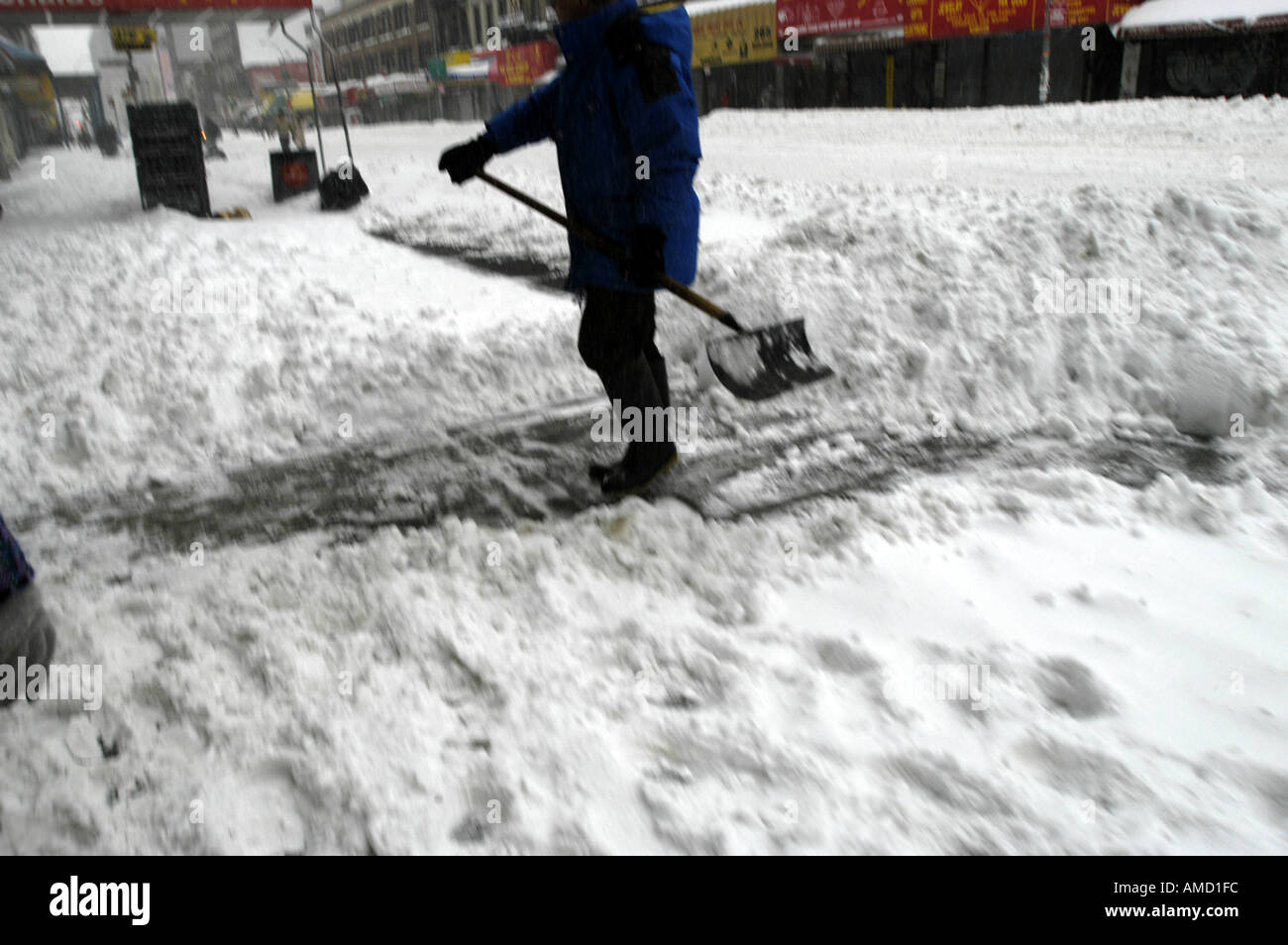 Figure shoulders down shadow facing left shoveling snow Stock Photo - Alamy
