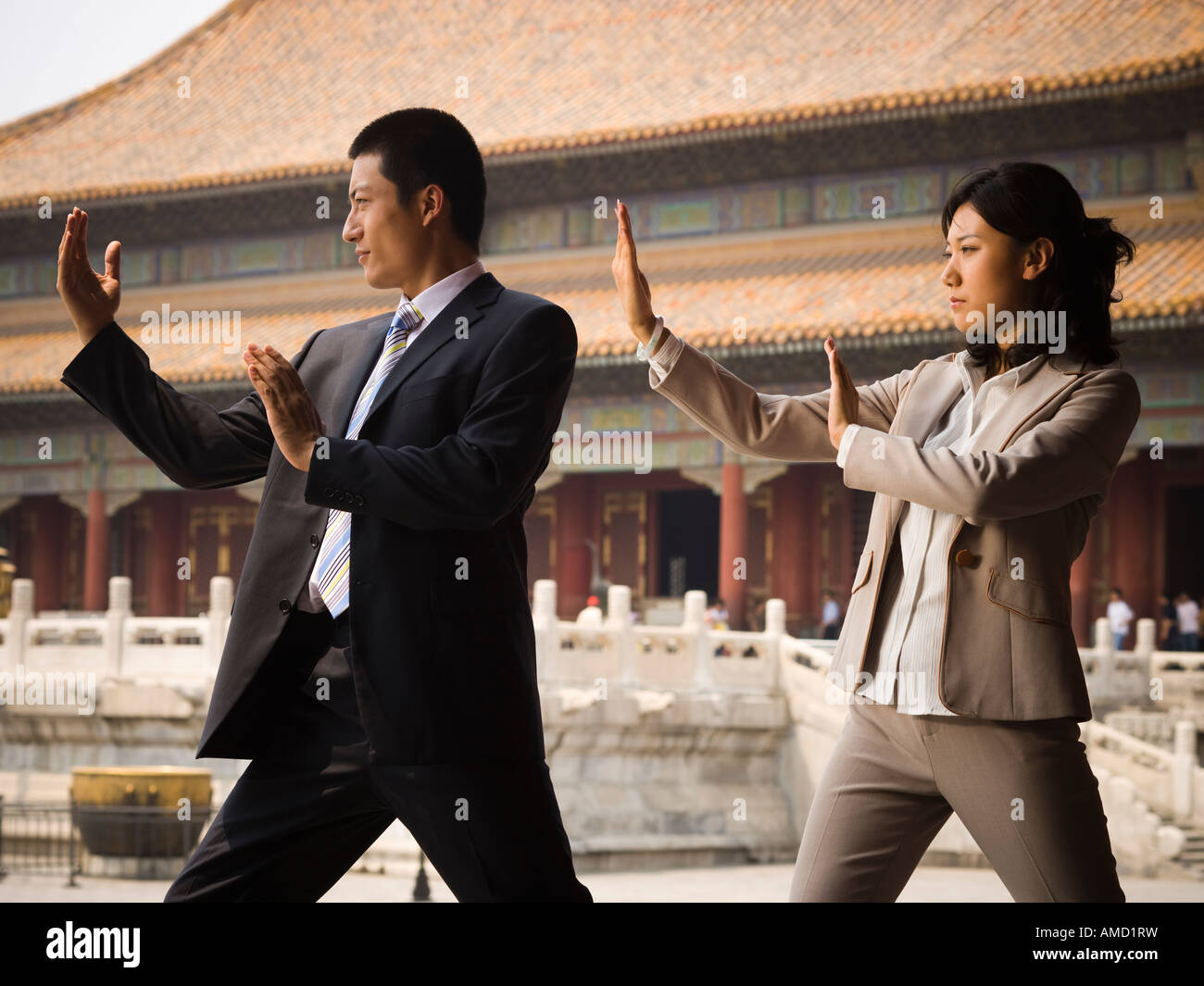 Businesswoman and man doing tai chi outdoors Stock Photo - Alamy