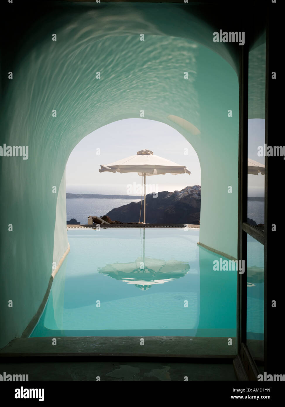 Arch with infinity pool and ocean with black rock and umbrella Stock ...